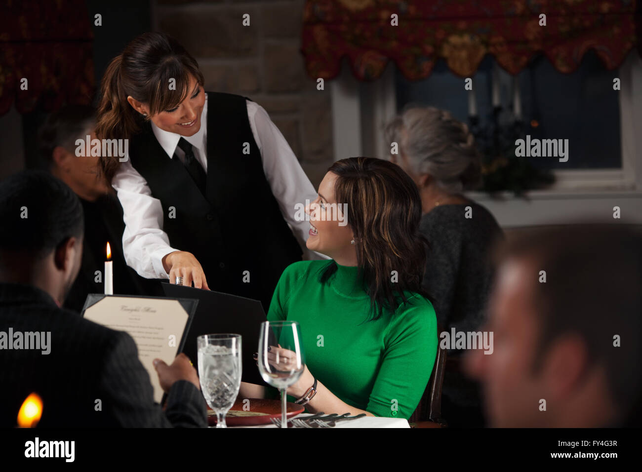 Series with a variety of people having a meal in a fancy restaurant ...