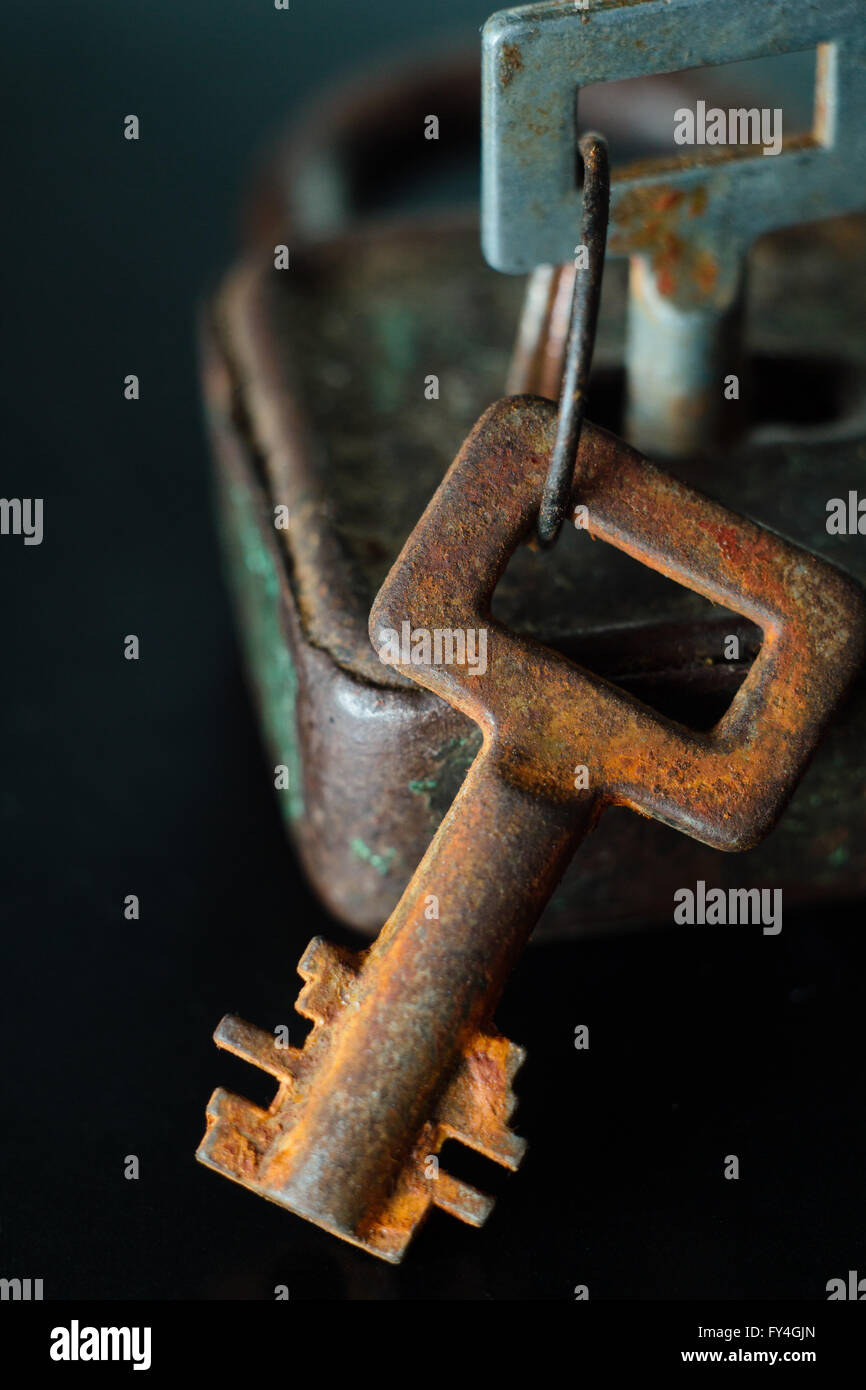 Old rusty key on dark background Stock Photo - Alamy