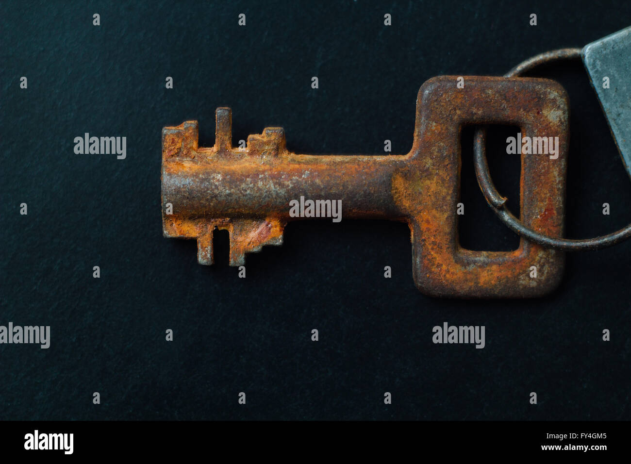 Old rusty key on dark background Stock Photo - Alamy