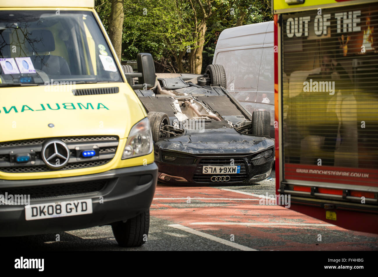 Black Audi upside crashed and upside down, ambulance and fire engine ...