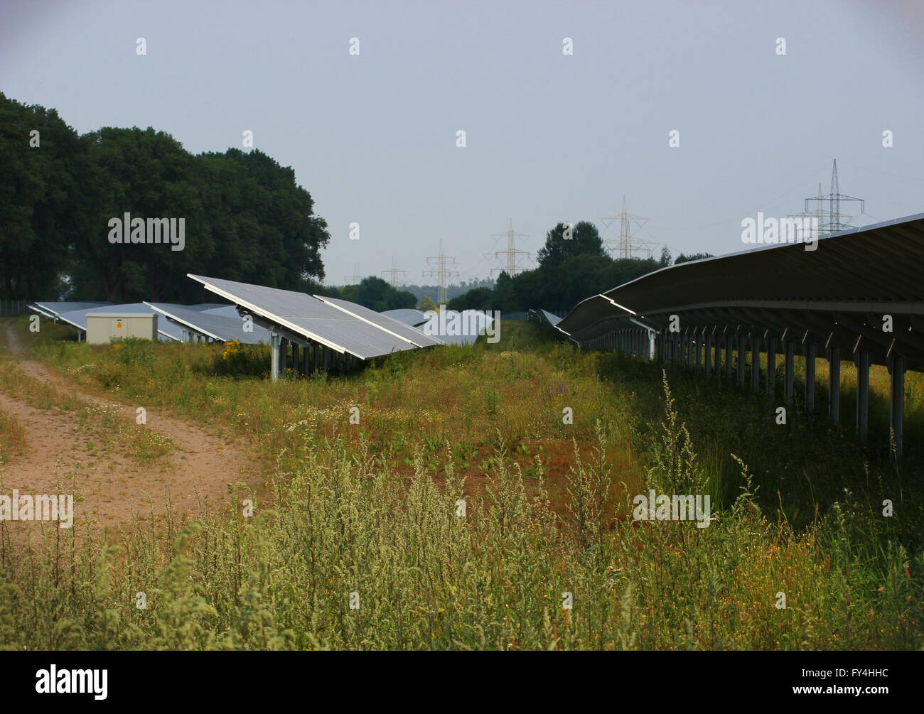 Solar power plant outside the town with power lines in the background ...