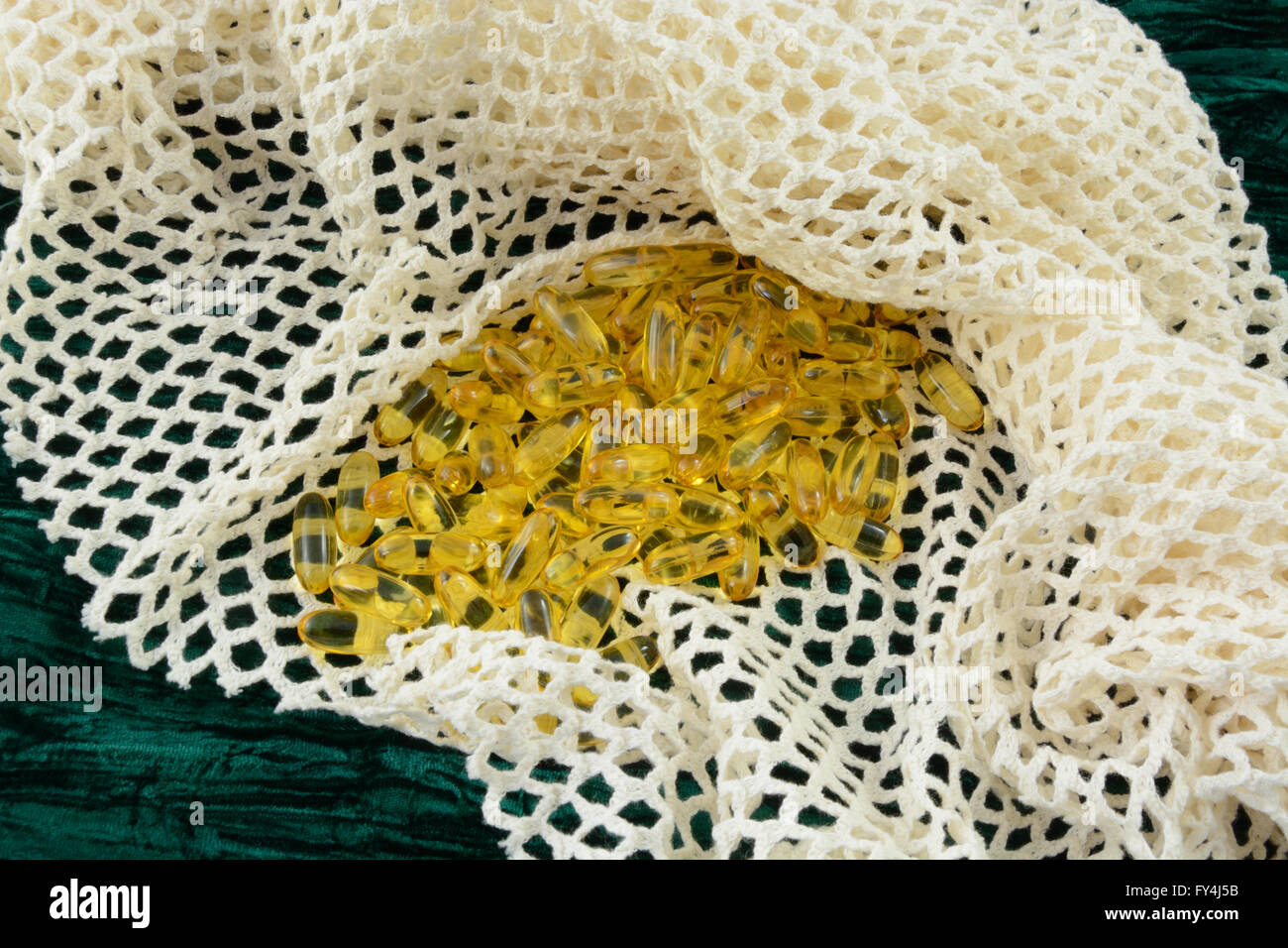 Omega 3 Fish oil capsules food supplements in netting Stock Photo - Alamy