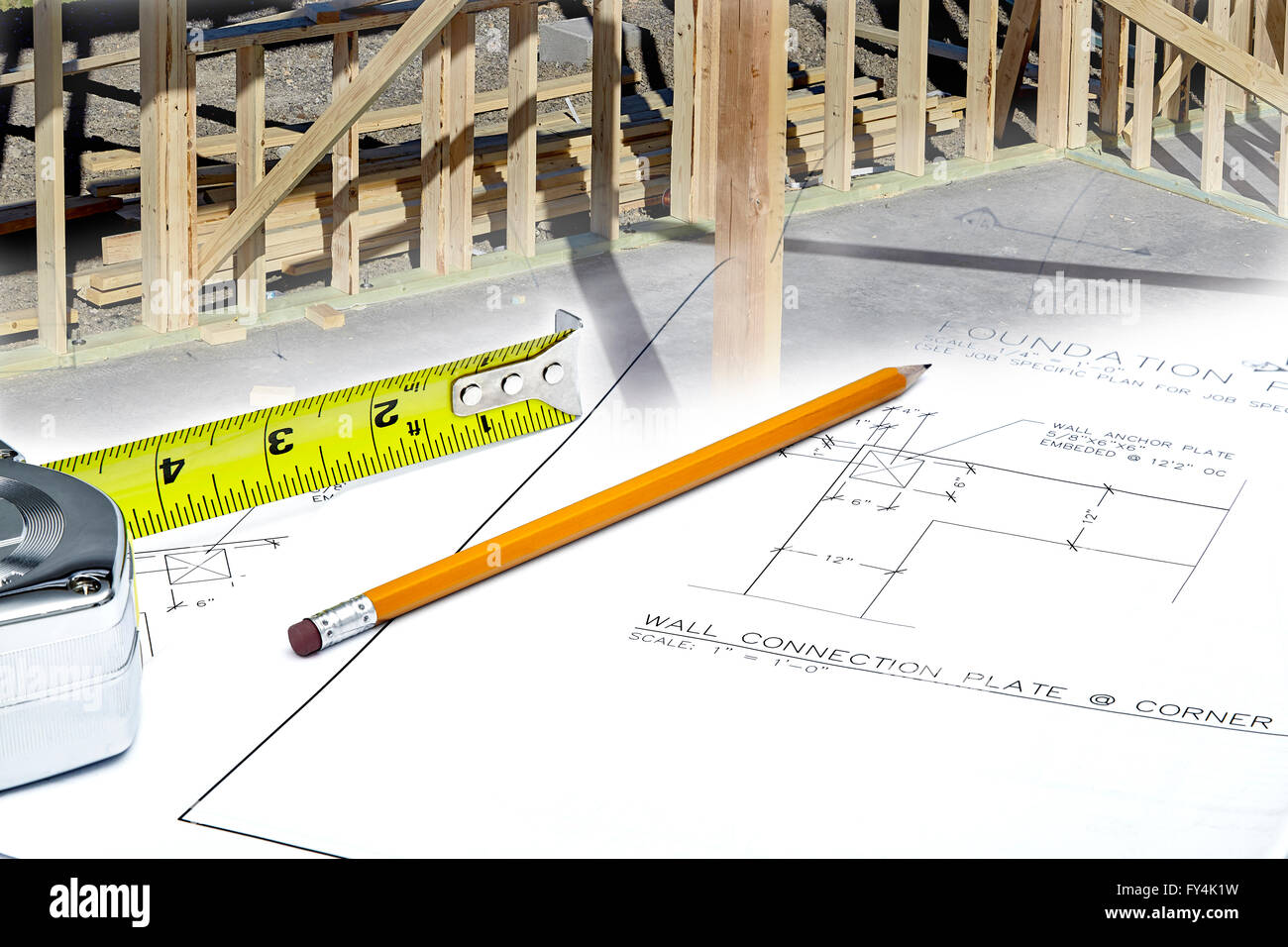 A set of blueprints with tape measure and pencil with wood structure in ...