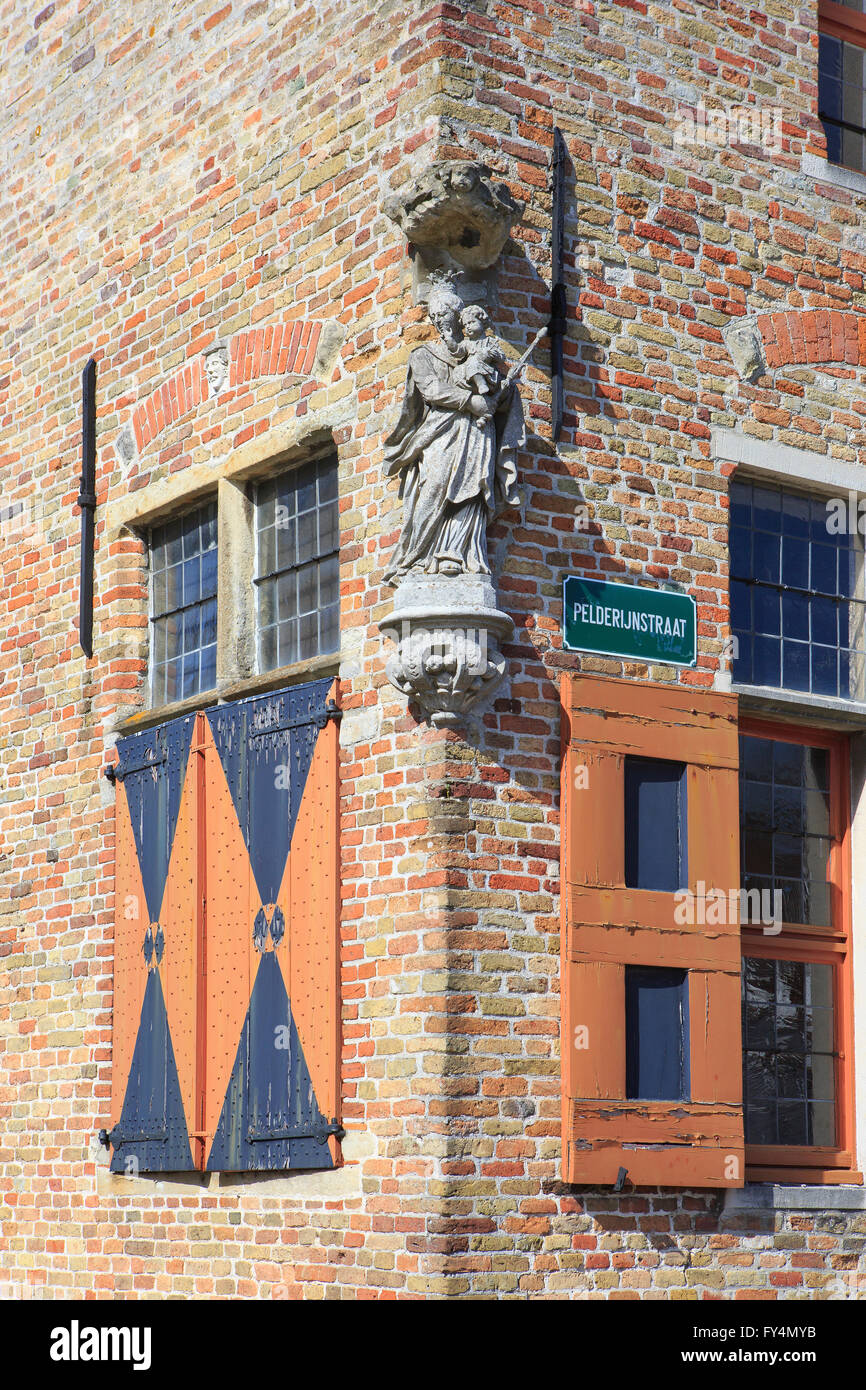 Statue of Madonna with Child on the corner of the Saint Trudo's Abbey ...