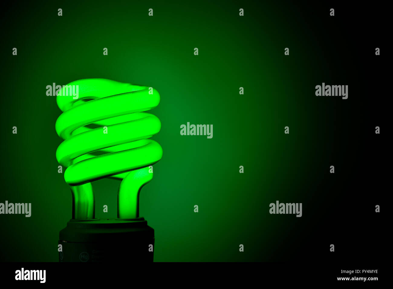 Typical compact flourescent light bulb in green color Stock Photo - Alamy