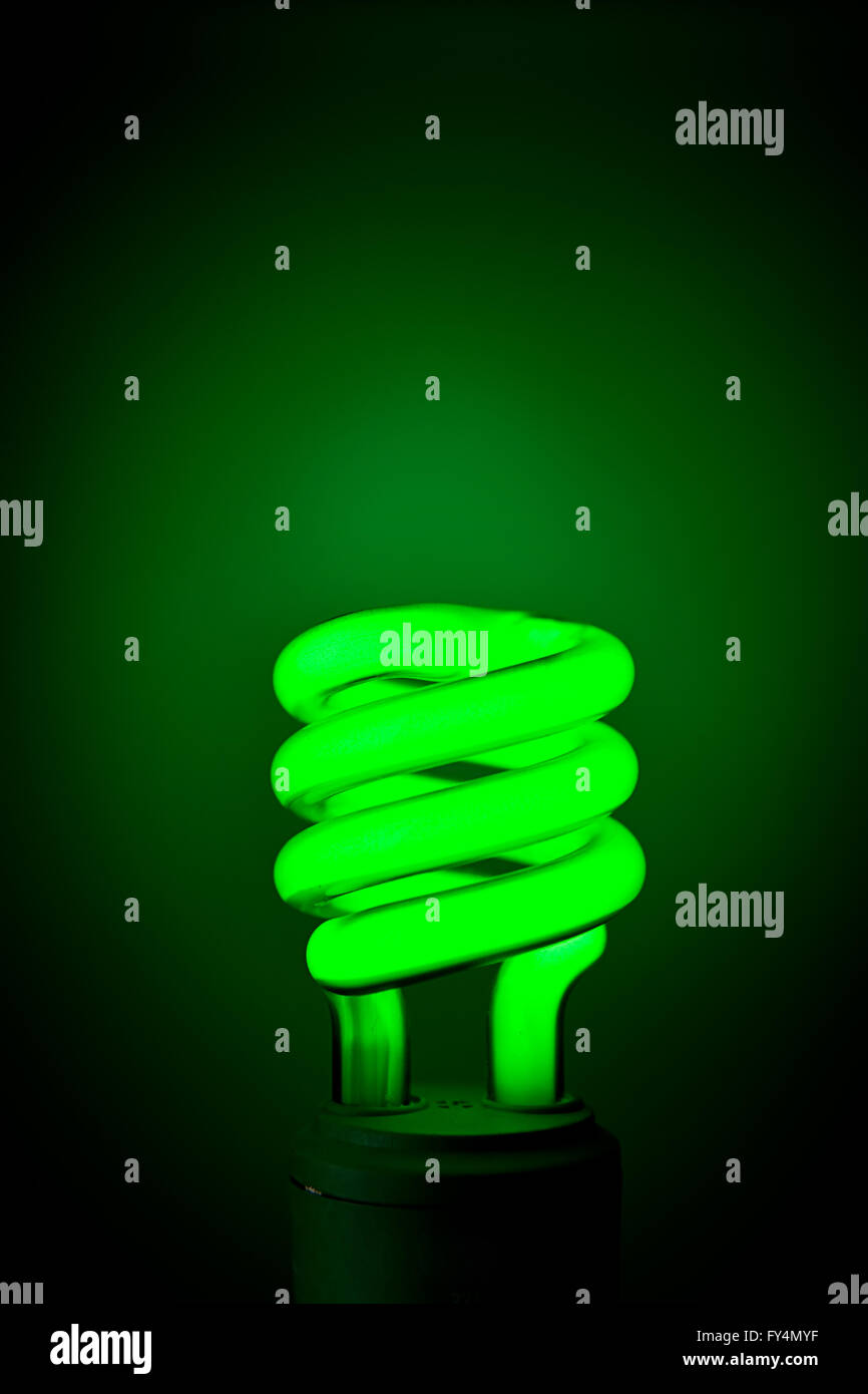 Typical compact flourescent light bulb in green color Stock Photo - Alamy
