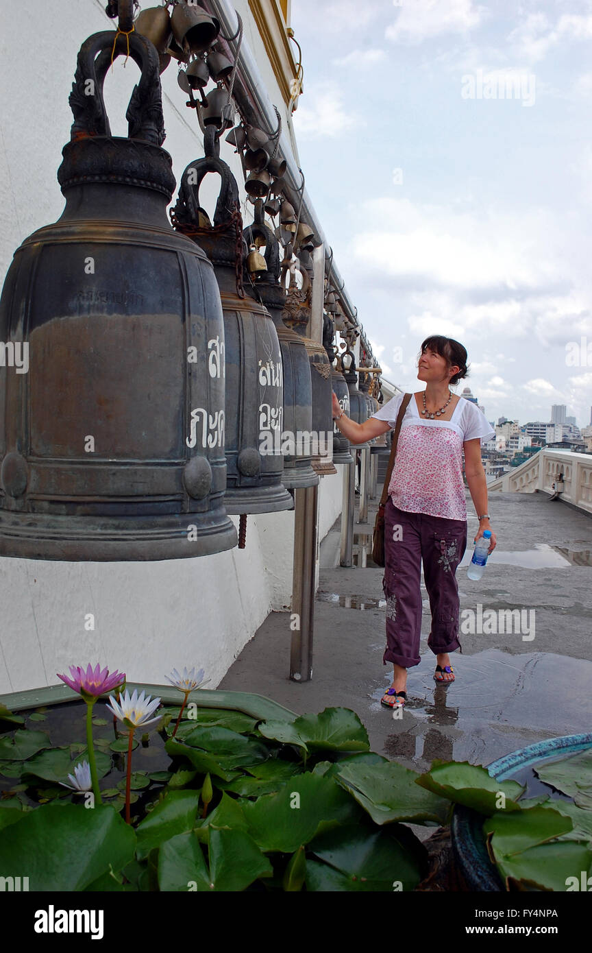 Tourist rings the temple bells, at the Golden Mount Temple in Bangkok ...