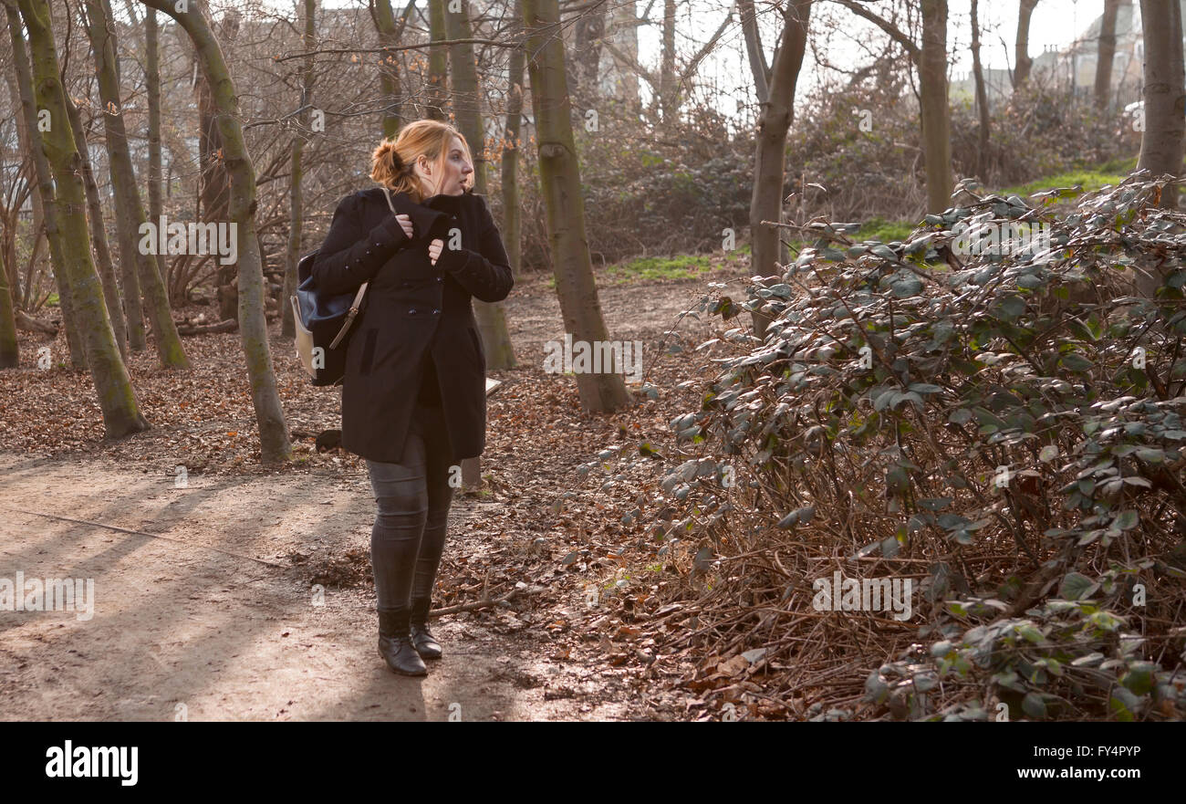 A woman is walking home through the park alone and she feels the fear ...