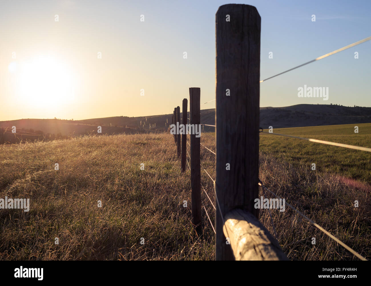Landscape of farm fence with beautiful sunrise Stock Photo - Alamy