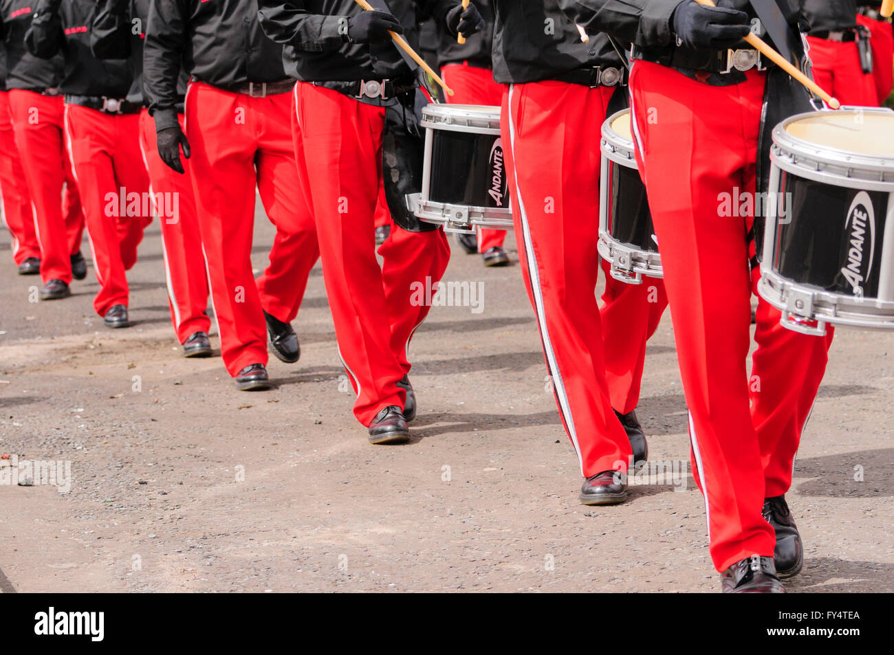 Bandsmen dressed in red trousers marching on a road Stock Photo - Alamy