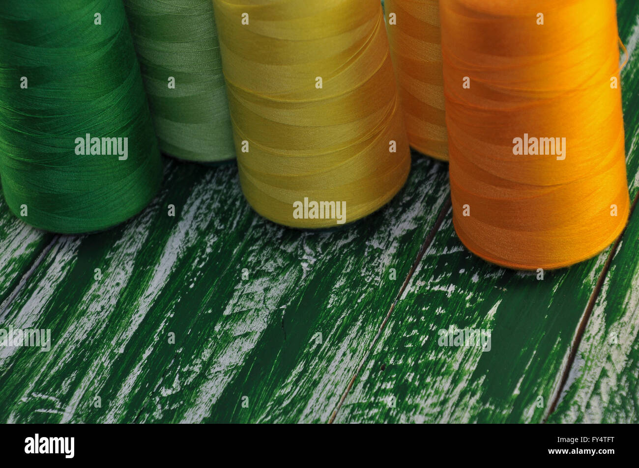 Colorful threads for sewing and embroidery on the background of an old ...