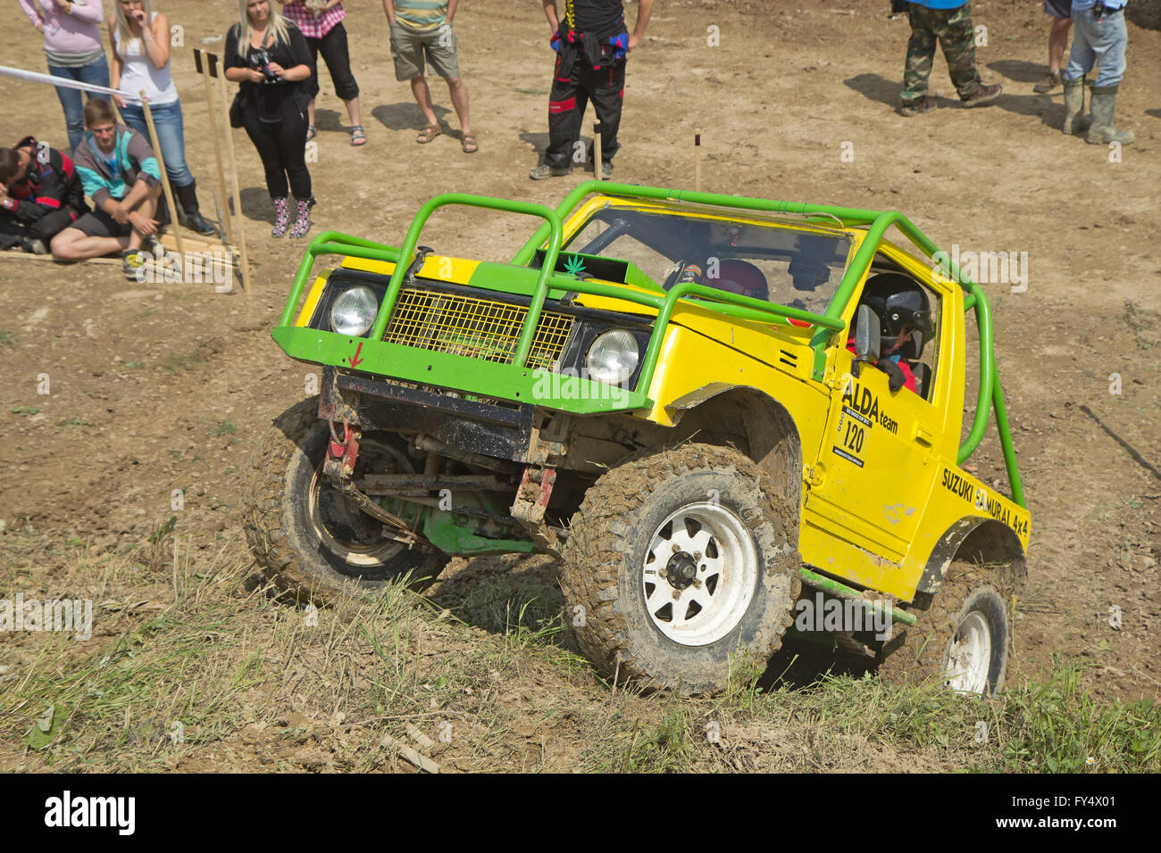 Yellow off-road car on a steep slope in the race Stock Photo - Alamy