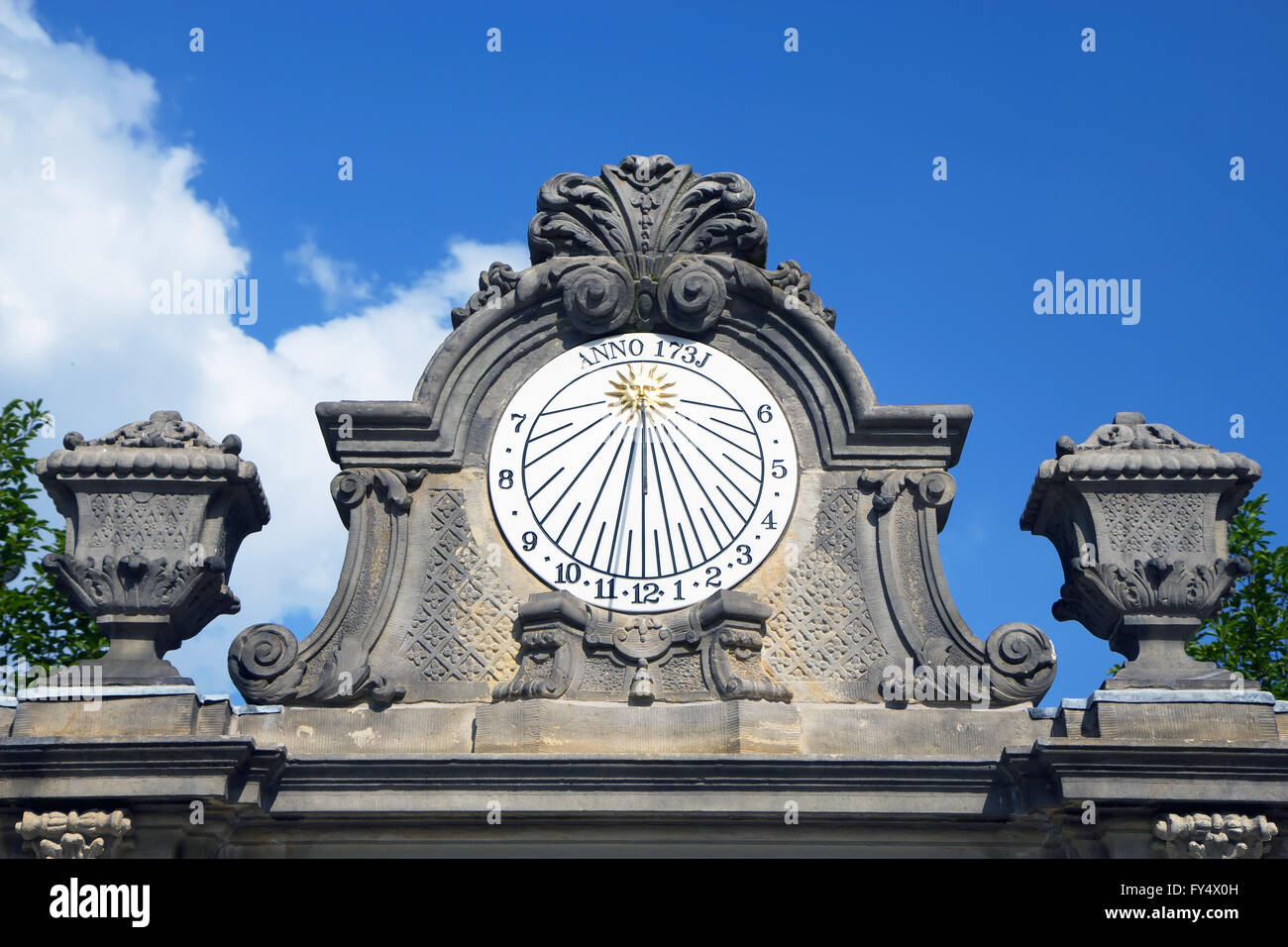 Old stone sundial with blue sky and clouds in the background Stock ...
