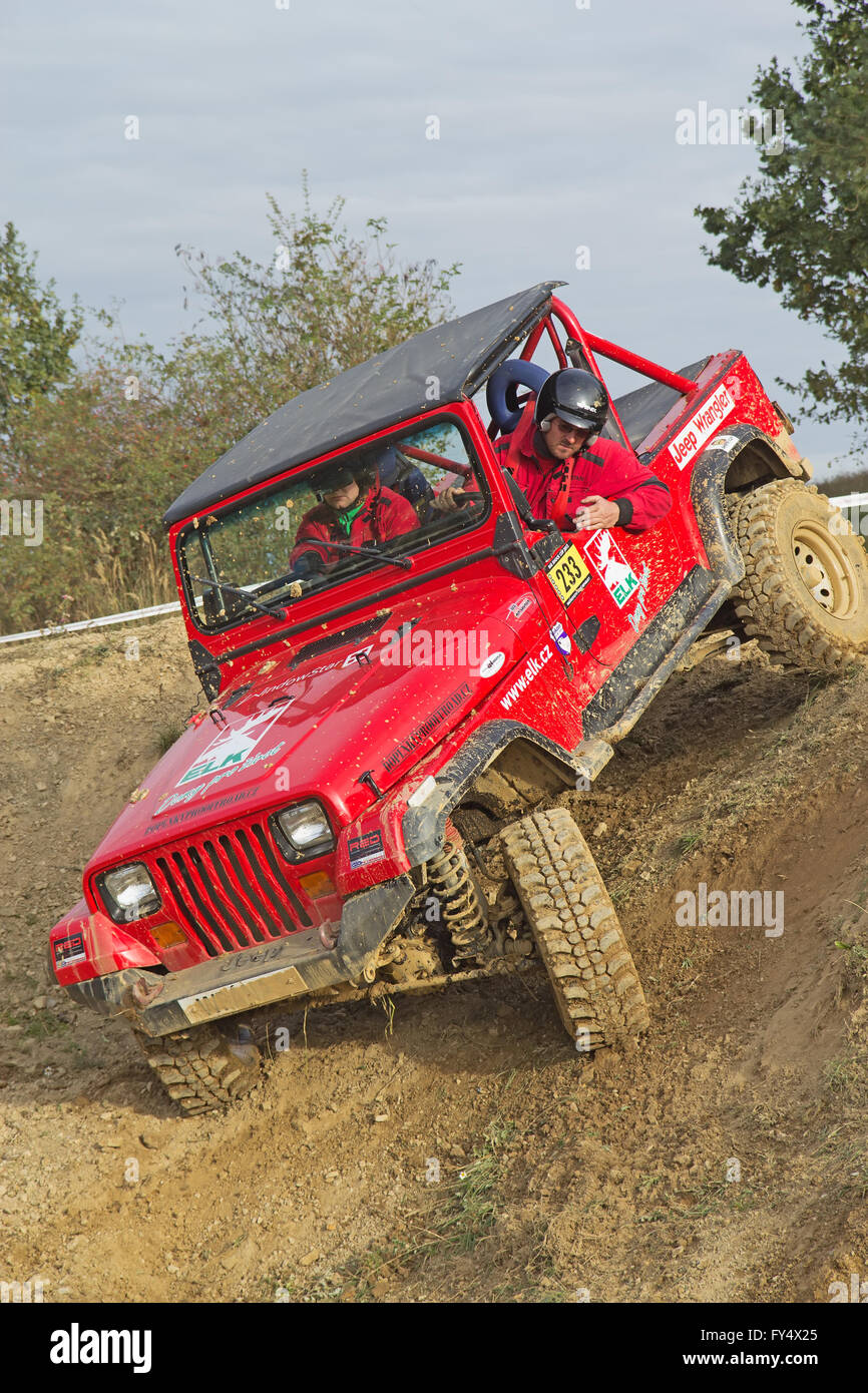 Red off-road car is in a difficult terrain Stock Photo - Alamy