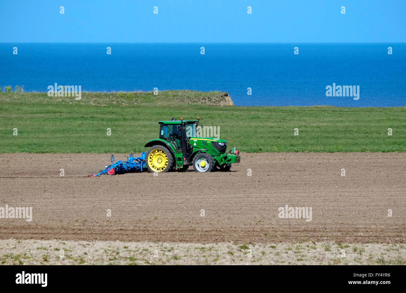 tractor and disc harrow on coastal farm land, weybourne, north norfolk ...