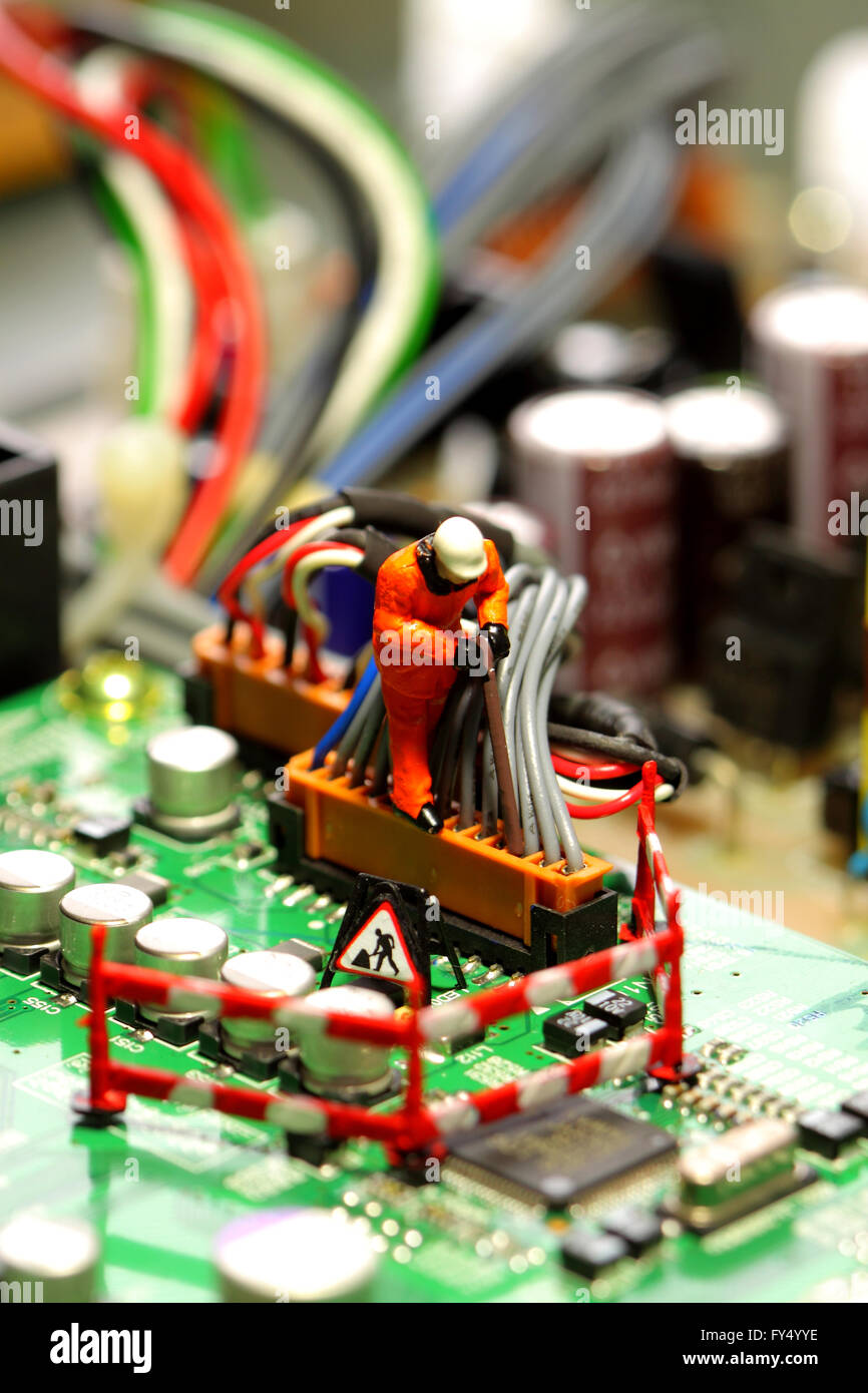 Miniature construction worker wiring circuit board Stock Photo - Alamy