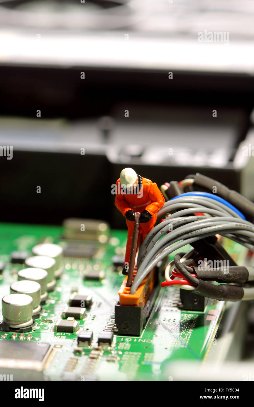 Miniature construction worker wiring circuit board Stock Photo - Alamy