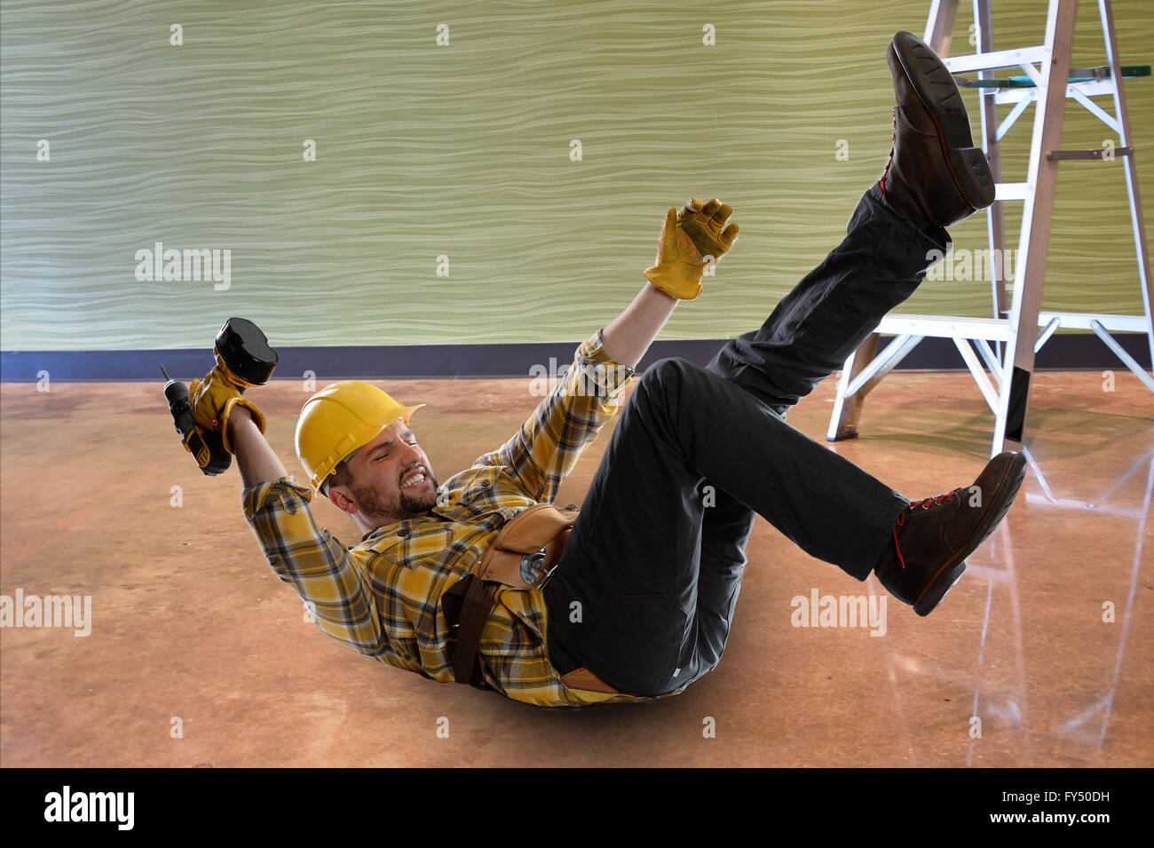 Worker embraces himself as he falls off of ladder Stock Photo - Alamy