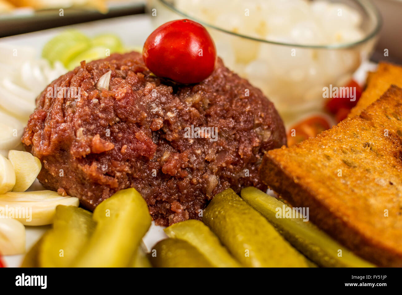 Raw beef Steak tartare with onion and toast Stock Photo - Alamy