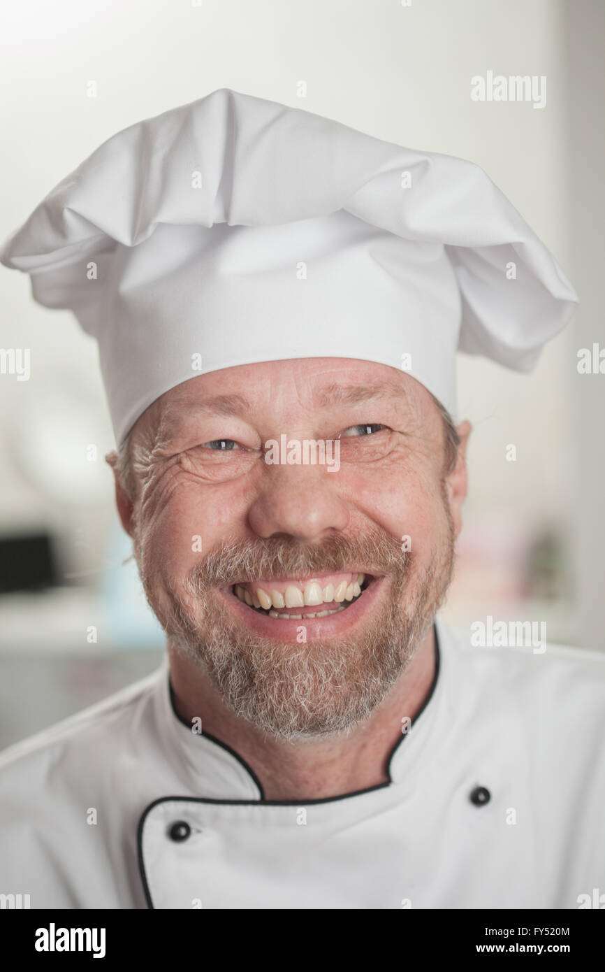 Cook in the White Cap laughs Stock Photo - Alamy