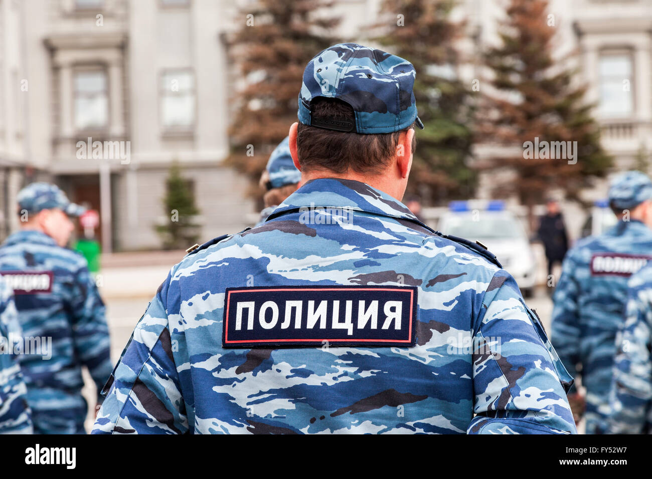 Russian policeman in uniform. Text in russian: "Police Stock Photo - Alamy