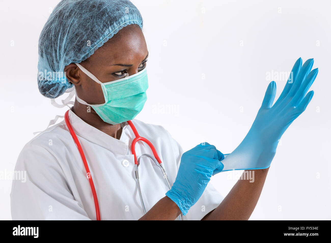 Portrait of african female doctor with mask and stethoscope putting ...