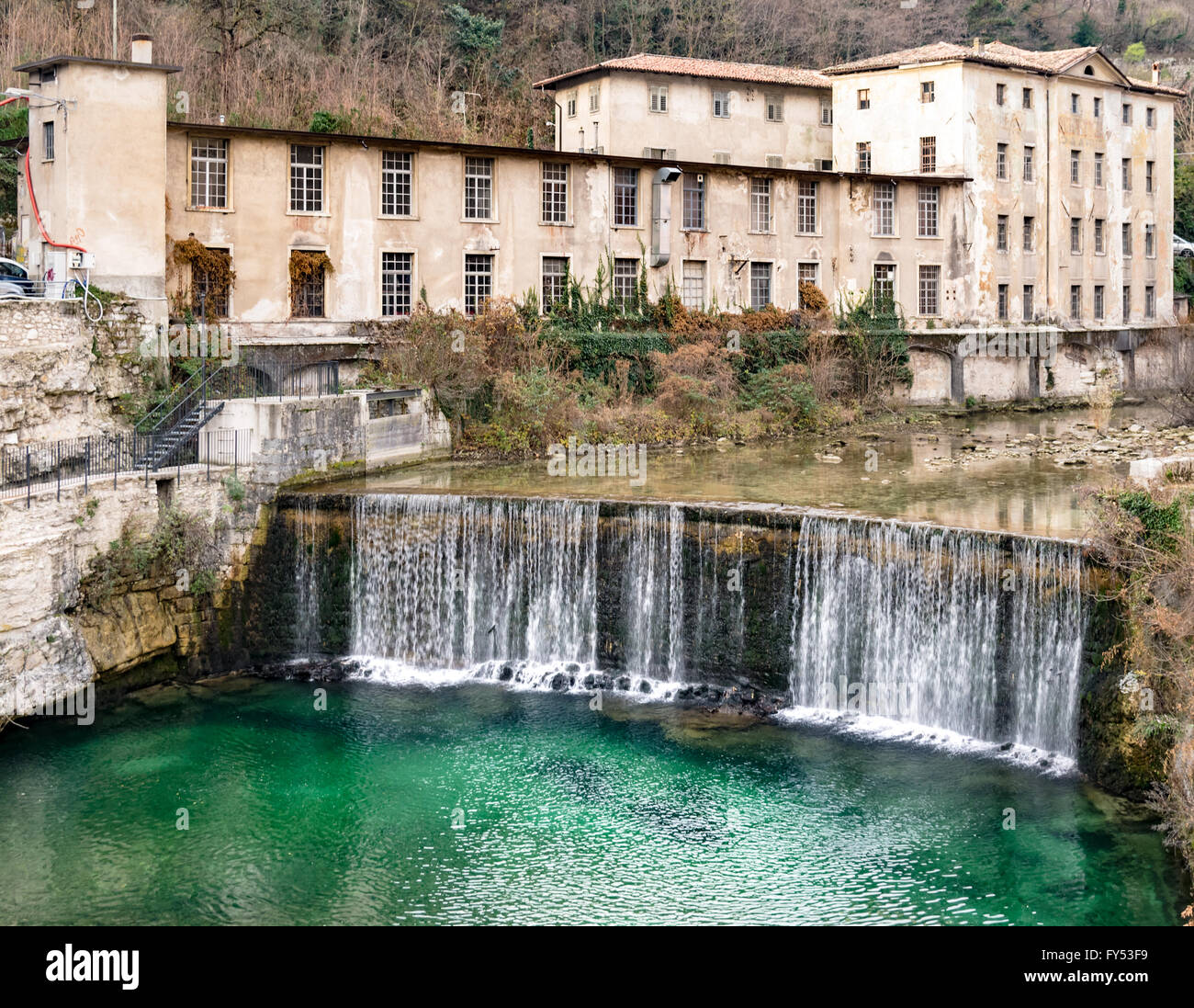 Old abandoned textile factory built on the river bank Stock Photo - Alamy