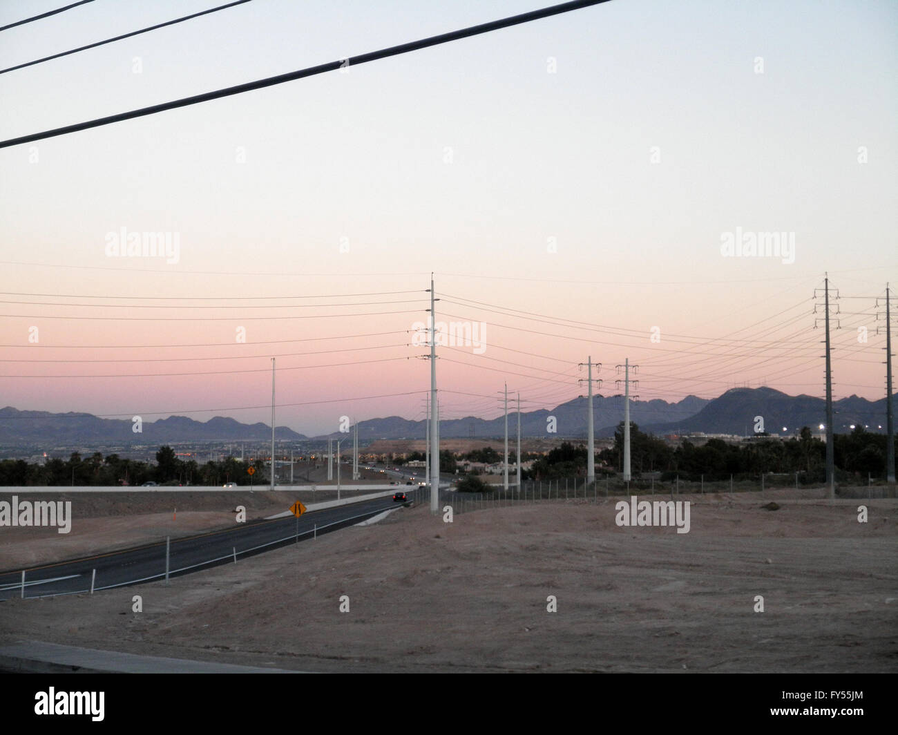 High Voltage Power-lines and Highway on-ramp at dusk in Las Vegas ...