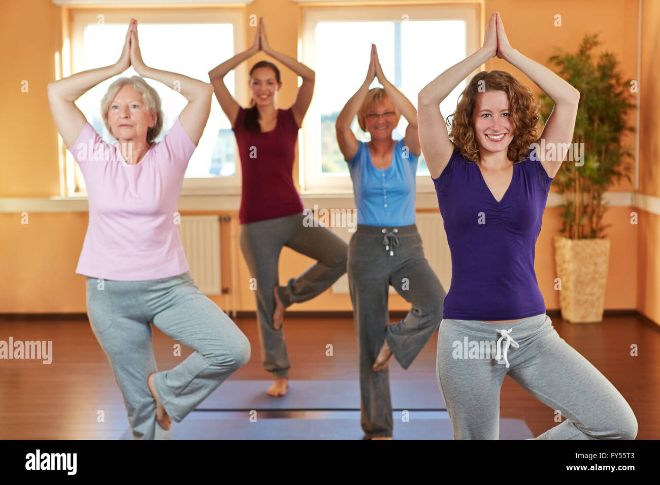 Happy group of women in yoga class in health club Stock Photo - Alamy