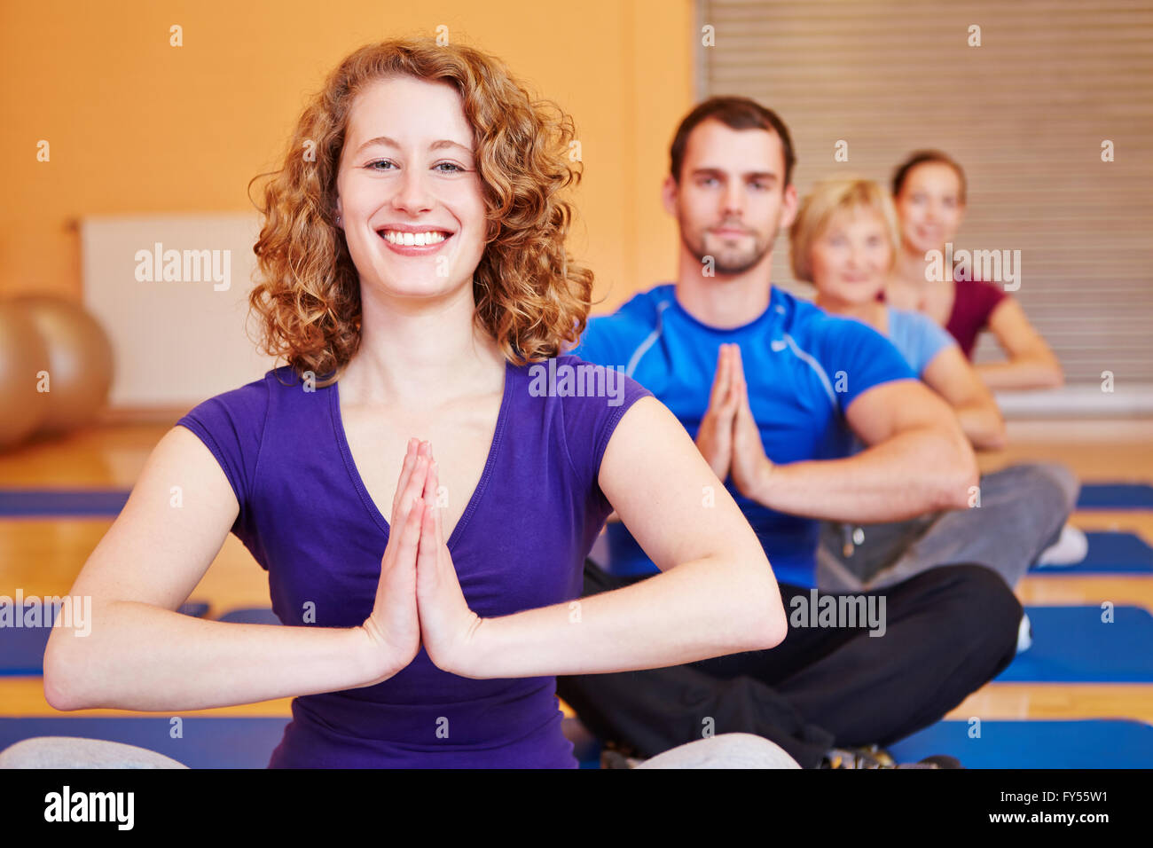 Happy woman smiling in yoga class in a fitness center Stock Photo - Alamy