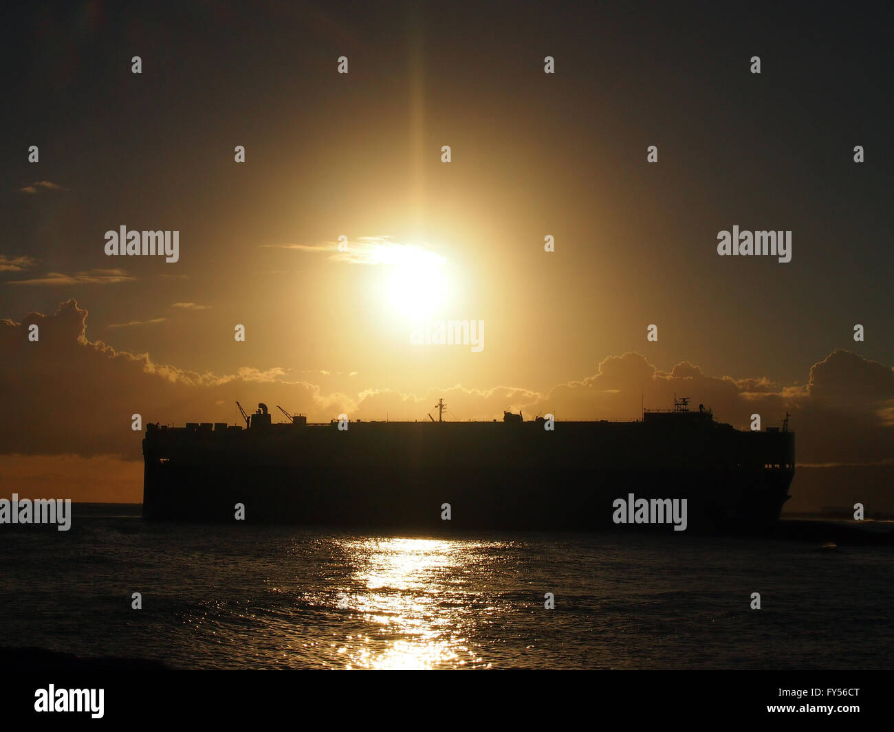Dramatic Sunset over Pacific Ocean with Cargo Ship passing through the ...