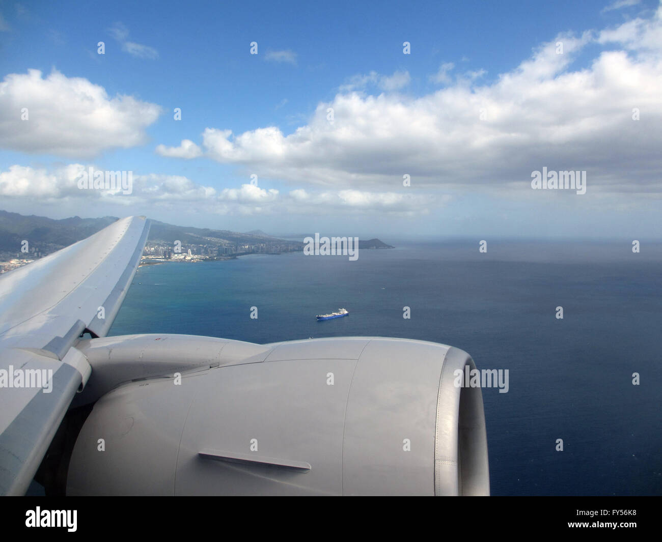 Aerial high in the sky shot of window view of plane leaving Honolulu ...