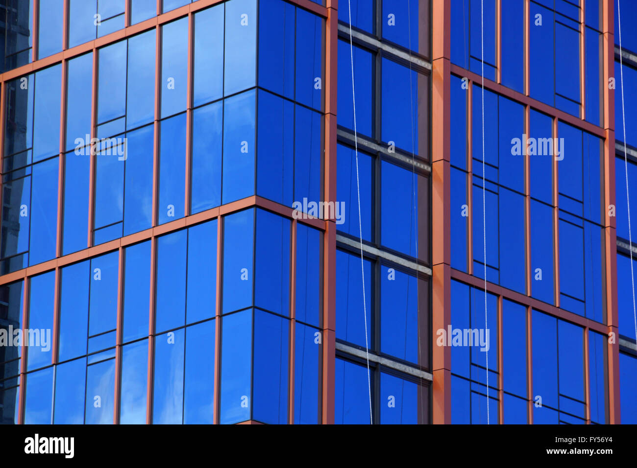 Blue Glass Windows reflect clouds with red lines framing windows Stock ...