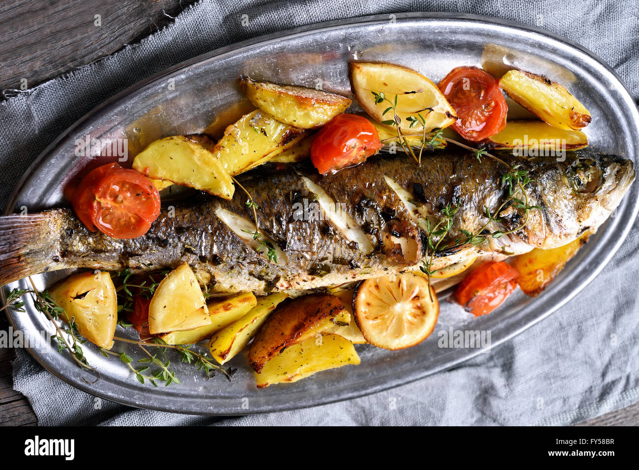 Grilled fish with potato wedges, top view, country style Stock Photo ...