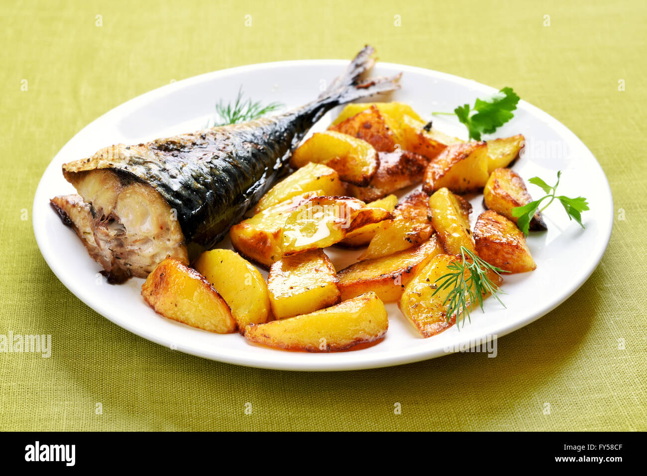 Roasted potato and mackerel fish on plate Stock Photo - Alamy