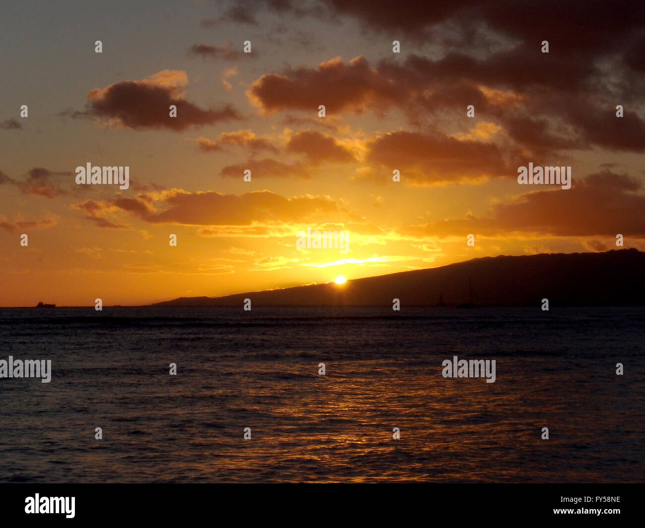 dramatic lighting as Sunsets behind Waianae mountains with light ...