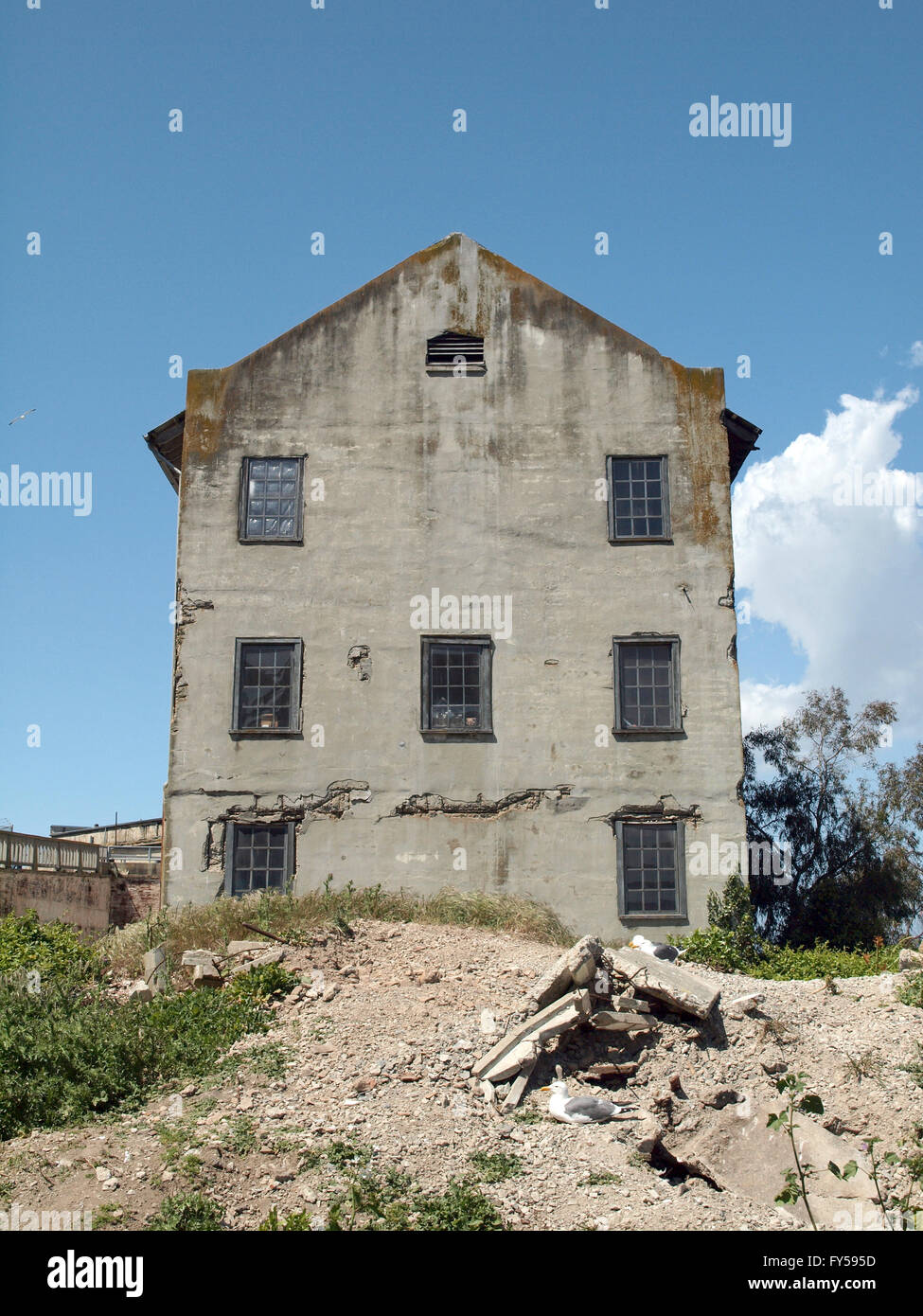Rundown Quartermaster building with seven windows and a blue sky on ...