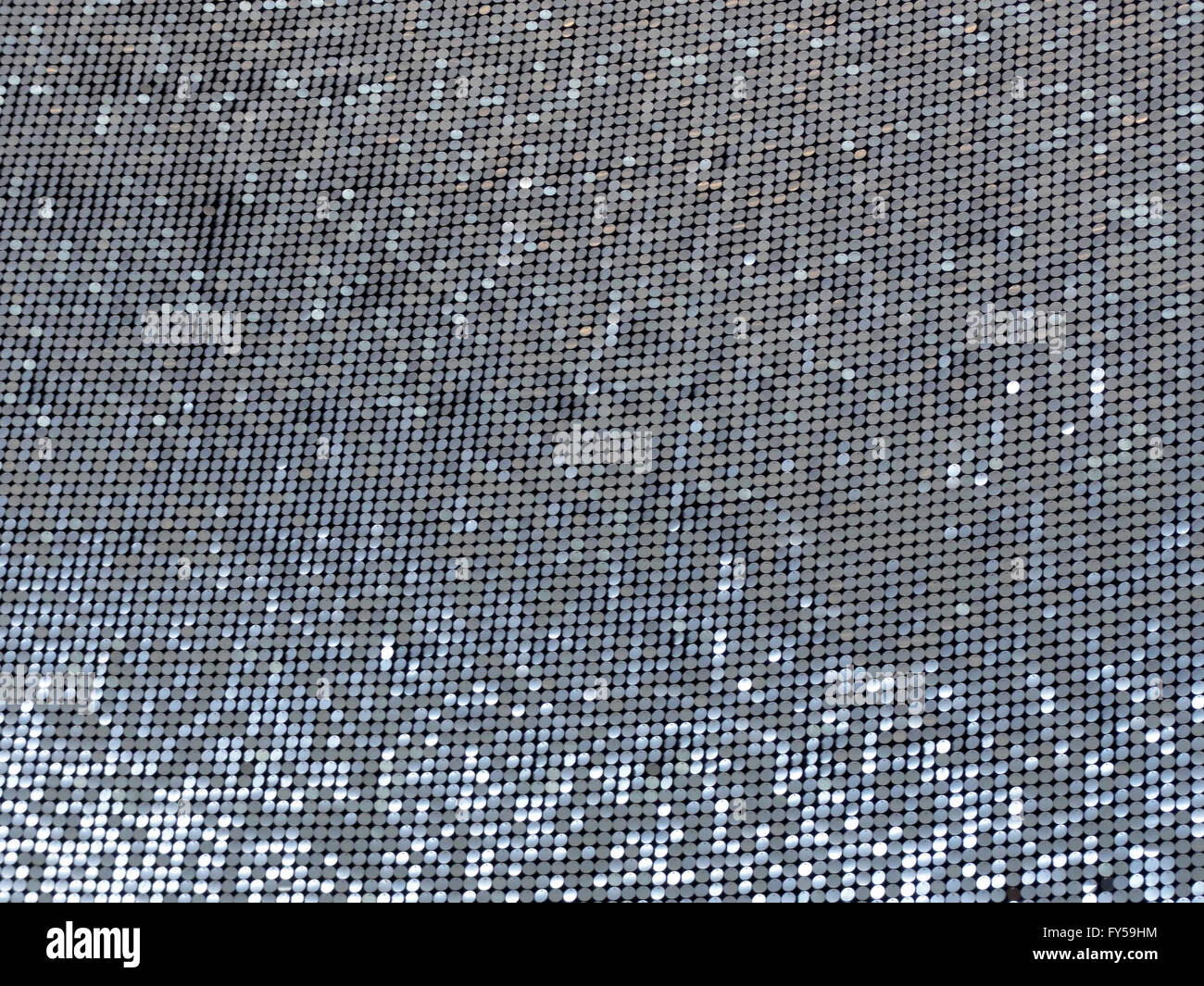 Pattern of Circles of silver metal shimmer in the light each doing ...