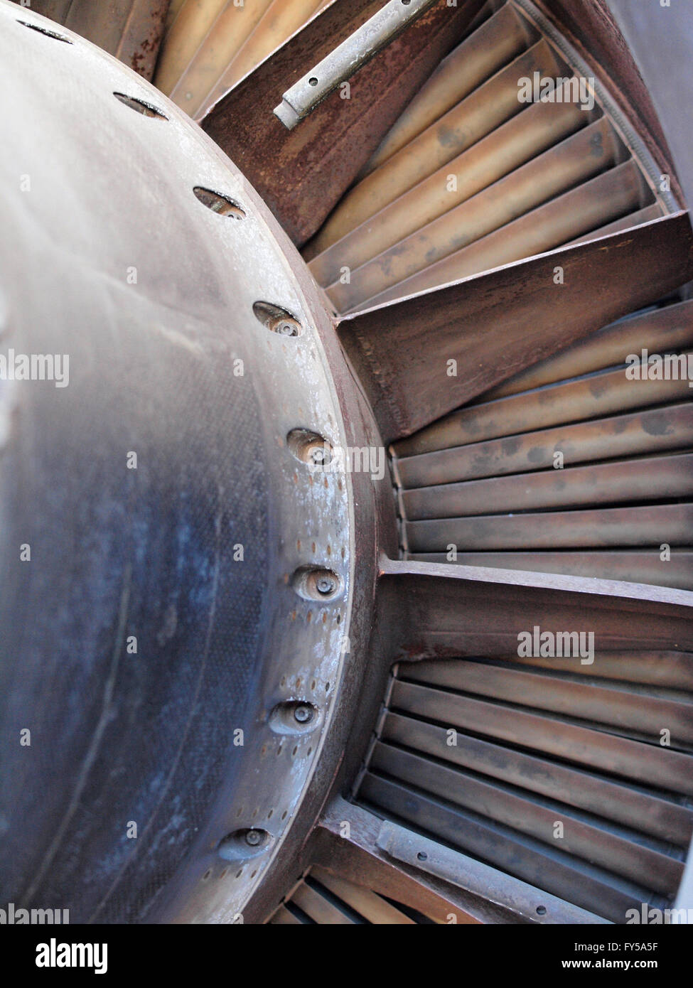 Close up of turbine and fan blades of a jet engine with signs of wear ...