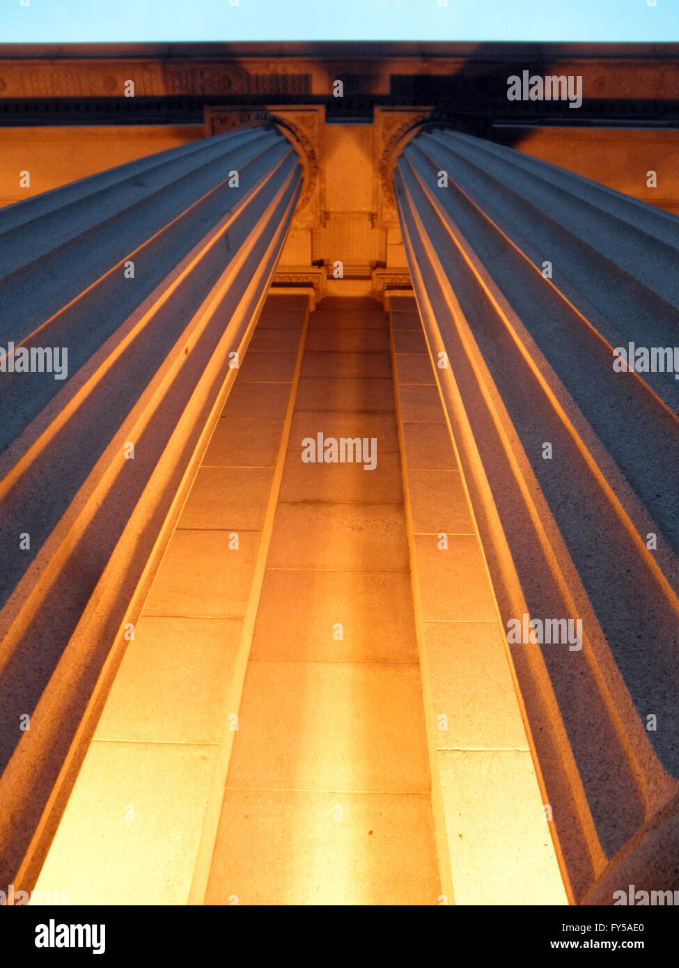 Looking upwards at Columns light up with Orange light at Dusk in San ...