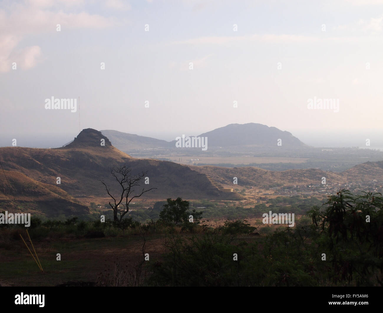Waianae Dry Landscape with trees, mountains, town, and ocean in the ...