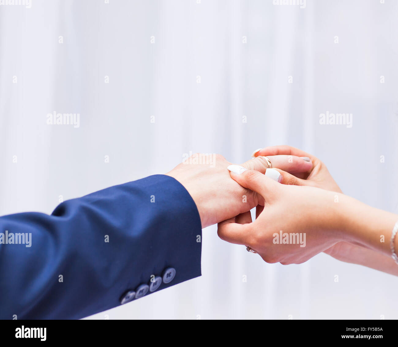Bridegroom putting wedding ring on hi-res stock photography and images ...
