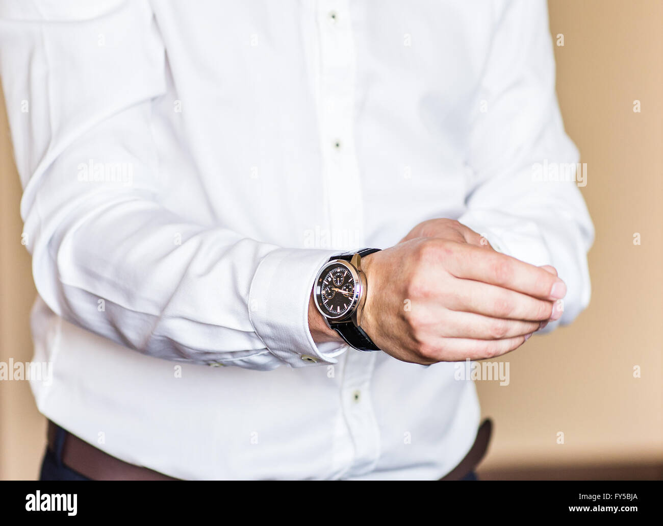Man puts a watch hi-res stock photography and images - Alamy