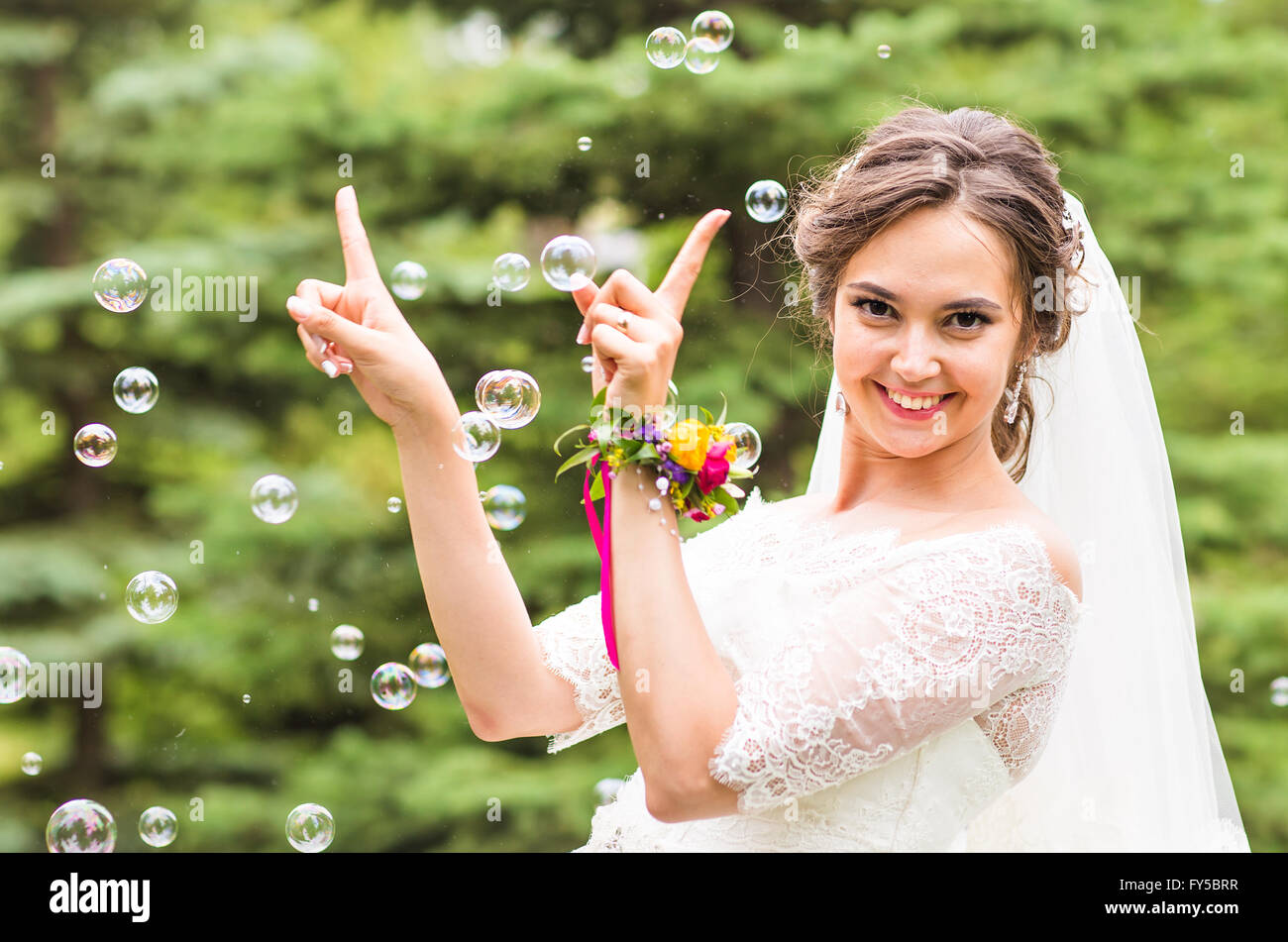 Young bride play with soap-bubble and joy smile Stock Photo - Alamy