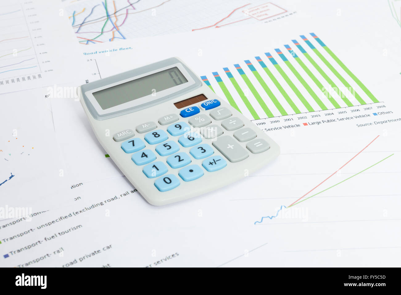 Data charts with calculator on the table Stock Photo - Alamy
