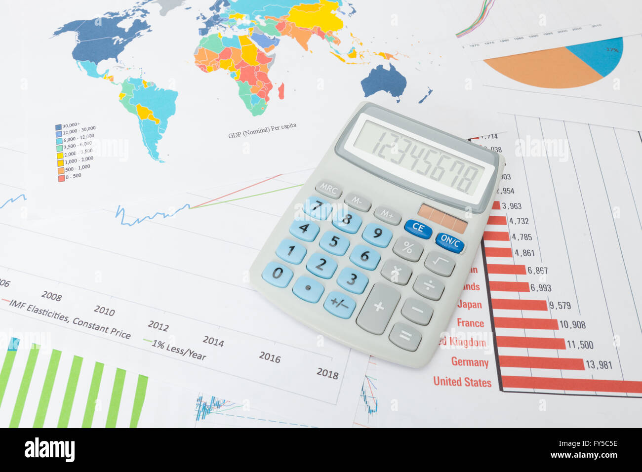 Data charts with calculator over it Stock Photo - Alamy