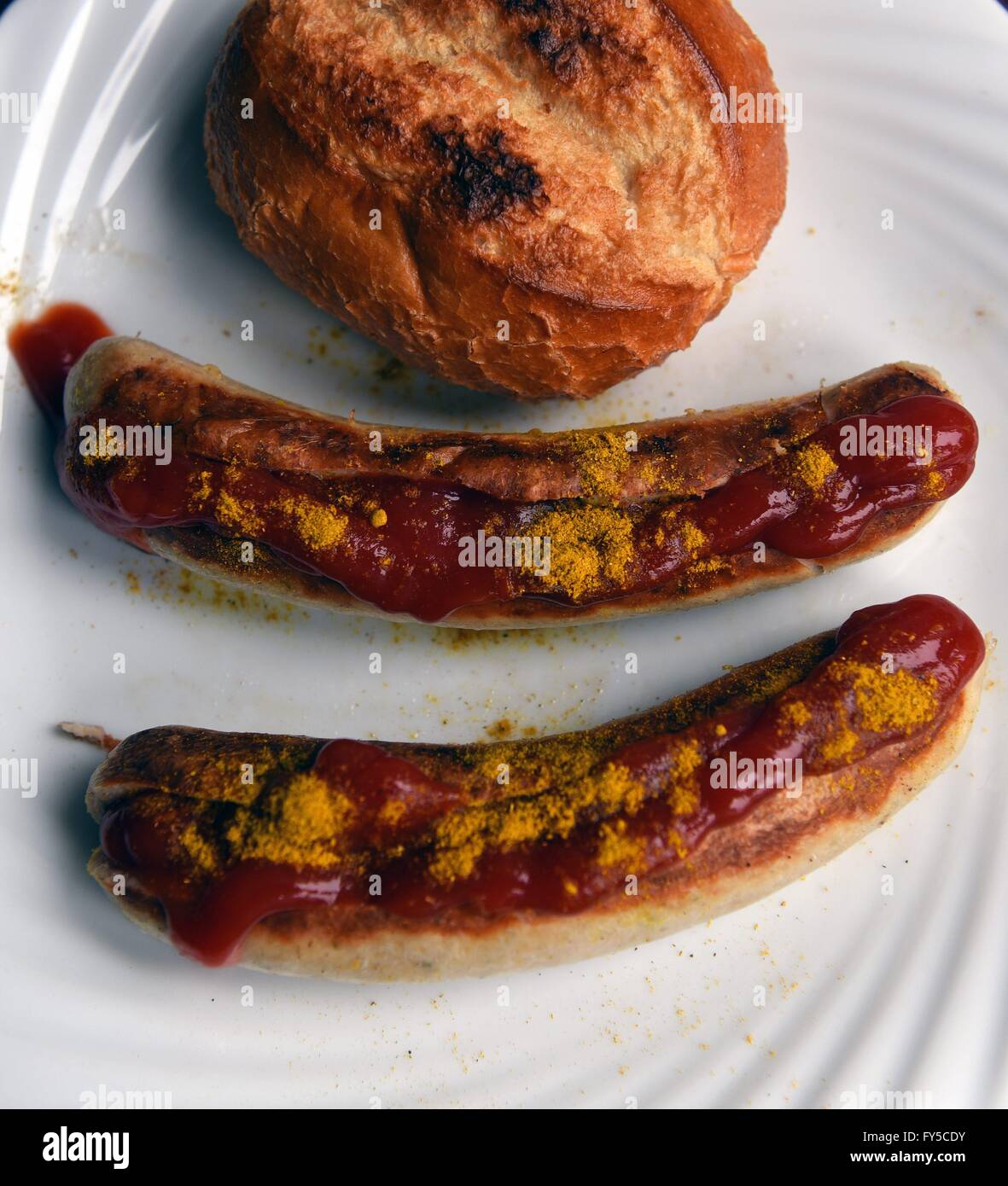 Currywurst - sausage with ketchup and curry served with a roll - food ...