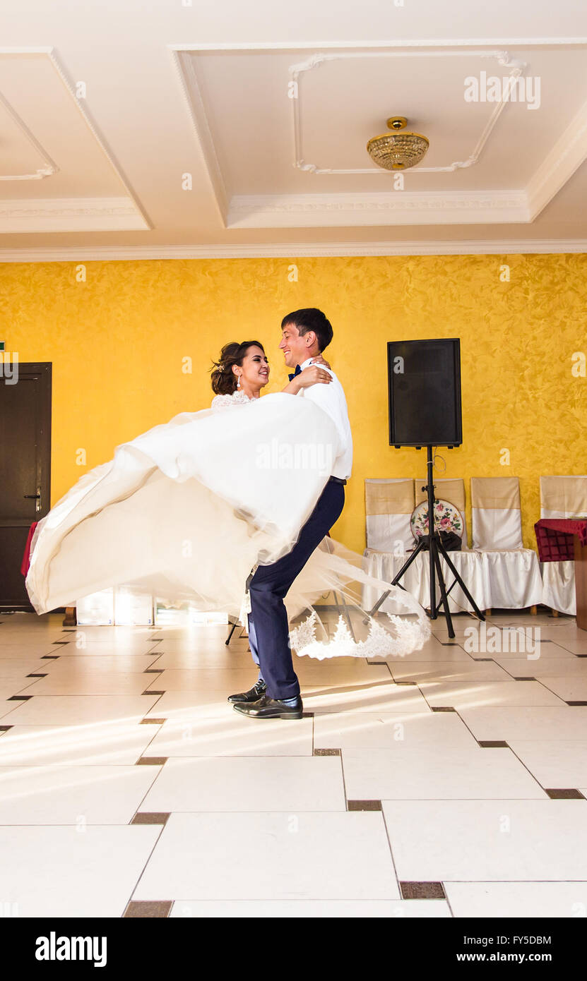 beautiful caucasian couple just married and dancing their first dance ...