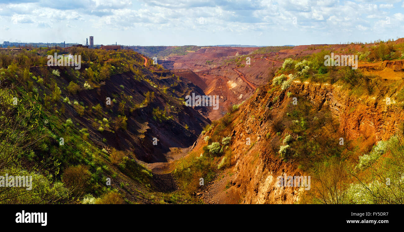 Panoramic view to extended colorful open-pit mine with drawn hills in ...