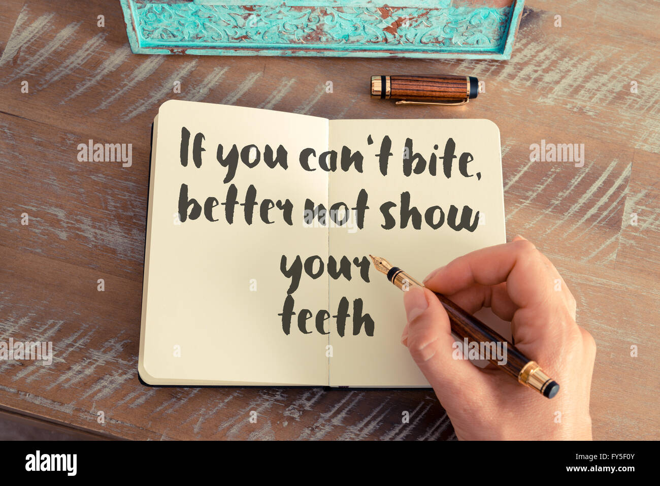 Handwritten quote If you can't bite, better not show your teeth Stock ...